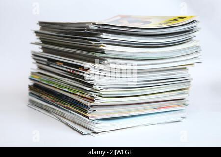 A large stack of printing magazines on a white background. Lots of ...