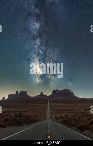 Breathtaking scenery of butte rocky outcrop formations near cars with ...