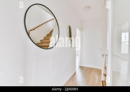 Interior passage way with mirror on wall in modern house Stock Photo ...