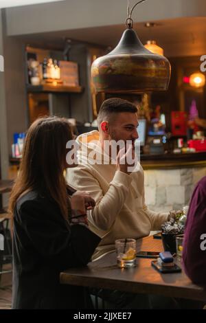 Two amazing and attractive couples are smiling and talking while ...