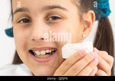 little girl with plaster cast of teeth and with the metal apparatus on ...