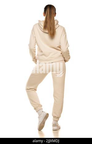 Adult woman in white tracksuit running on a treadmill in a gym Stock ...