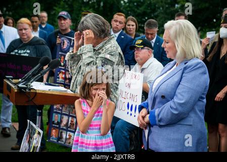 Brielle Robinson, 9, second from right, is comforted by United States ...