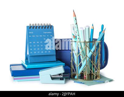 Pencil case with school stationery and calendar on blue background ...