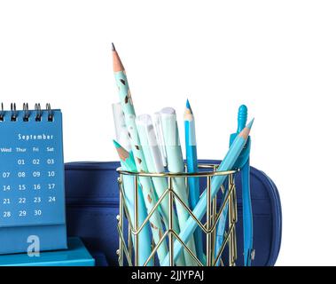 Pencil case with school stationery and calendar on blue background ...