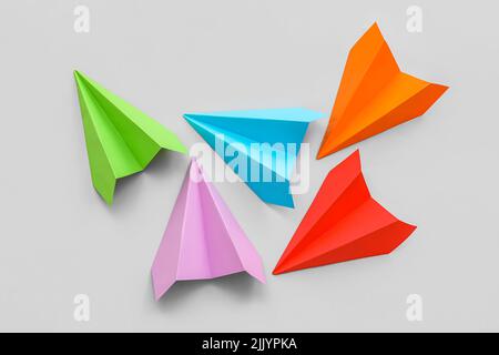 Colorful paper planes on grey background Stock Photo - Alamy