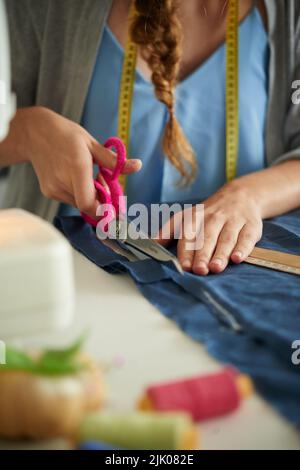 Tailor hands cutting fabric for fashion design Stock Photo - Alamy