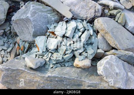 A stone crumbled into small pieces by the river Stock Photo - Alamy