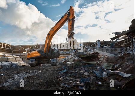 Excavator destroyer removes debris Building demolition Stock Photo - Alamy