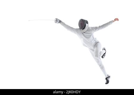 Dynamic portrait of young man, fencer in in fencing costume with sword ...