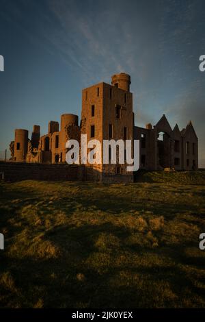 The ruins of the 16th century Slains Castle, perched high on the cliffs ...