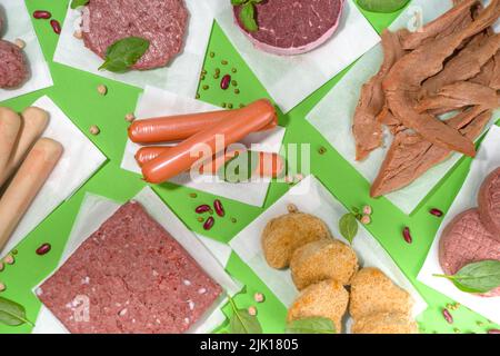 Lab-grown or plant based red meat steaks over green background Stock ...