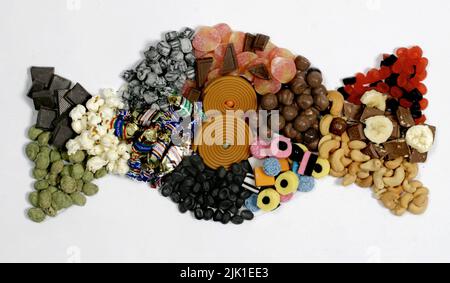 Different kinds of candy outside candy bag Stock Photo - Alamy