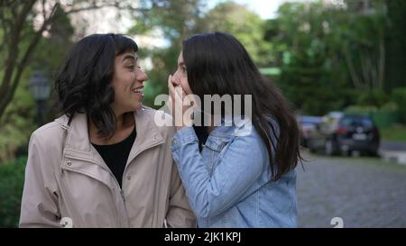 Female friend reacting with shock and surprise to news while walking ...