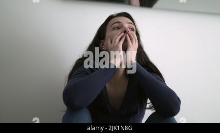 One fearful person overwhelmed with emotional problems. Ashamed woman ...