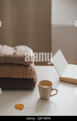 Composition with book, warm clothes, cup of cocoa drink and fir ...