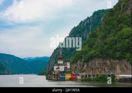 The Danube River narrows. You see the old church and monastery on the ...