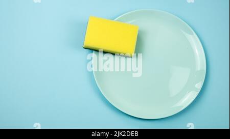 Cleaning sponge on a green plate on a gray background Stock Photo - Alamy