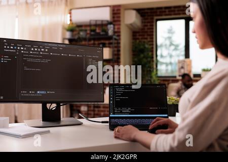 Female freelance developer coding and programming. Coding on two with ...