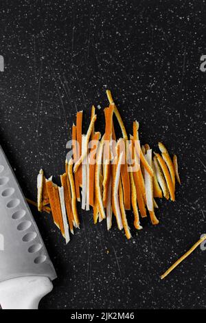 Orange rind thinly sliced, julienned orange rind on cutting board ...