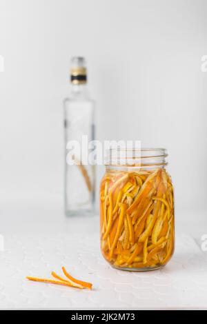Making orange extract, orange peel in a glass jar, sliced orange rind ...