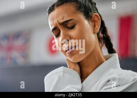 Karate, sports injury and neck pain of man at fitness club for martial ...