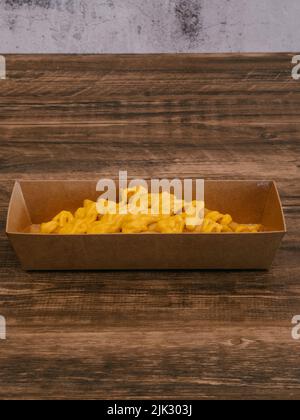 Cheese Fries in a cardboard tray with nacho cheese Stock Photo - Alamy