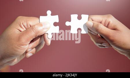 Working together to put things together. two unrecognizable ...