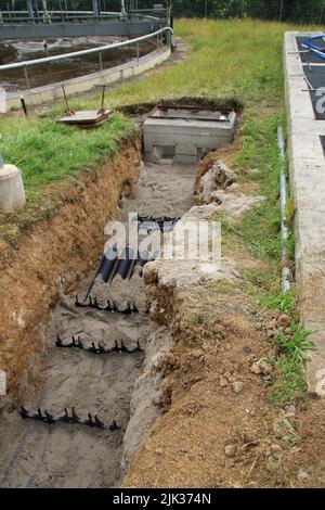 Empty conduits for cables lie in a trench Stock Photo - Alamy