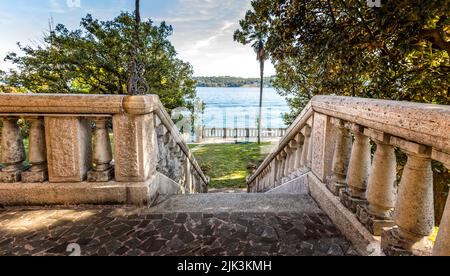 Stairs leading to a beautiful backyard towards a lake, luxury lifestyle ...