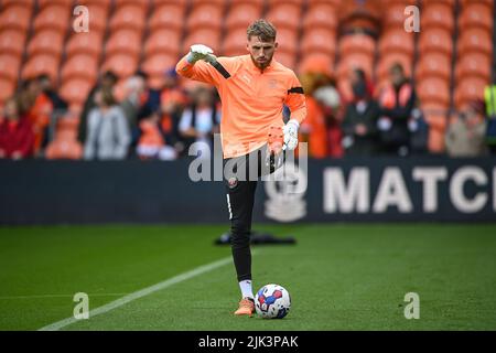 Daniel Grimshaw #32 of Blackpool stretches during the pre-game warmup ...