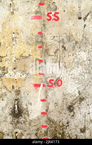 Tide gauge or tide staff on a harbour wall, showing chart datum, used ...