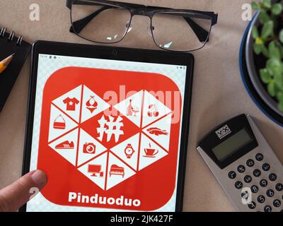 In this photo illustration, a Pinduoduo Inc. logo seen displayed on a ...