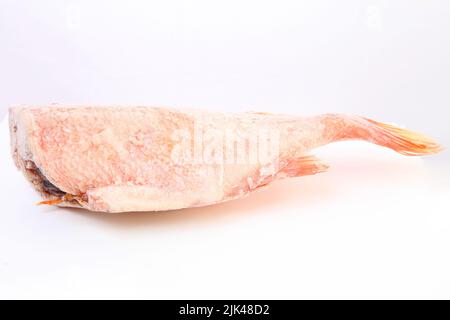 Frozen sea bass without a head. Frozen red fish Frost on the surface of ...