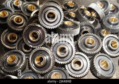 Lots of parts for big cars. Gears, shafts, sprockets in large ...