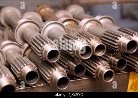 Lots of parts for big cars. Gears, shafts, sprockets in large ...
