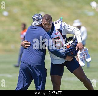 Denver Broncos head coach Nathaniel Hackett greets center Lloyd ...
