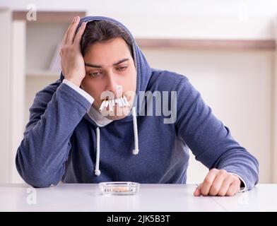 The young man having problems with narcotics at home Stock Photo - Alamy