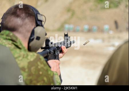 Ukrainian civilian takes part in a shooting training to learn military ...