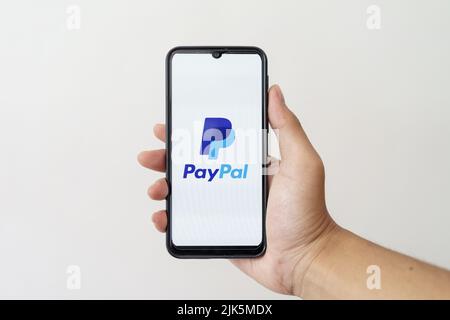 A hand holds smartphone shows PayPal logo Stock Photo - Alamy