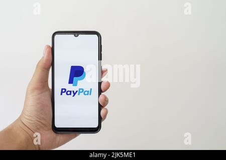 A hand holds smartphone shows PayPal logo Stock Photo - Alamy