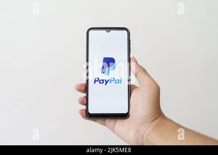 A hand holds smartphone shows PayPal logo Stock Photo - Alamy