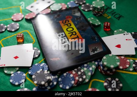 Smartphone with poket table on screen, playing cards and chip cards on ...