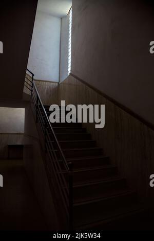 Staircase lit by a feeble light coming from a window Stock Photo - Alamy