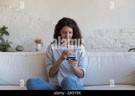 Beautiful hispanic woman holding virtual currency bitcoin and dollars ...