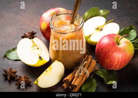 Apple jam with spices and fresh apples on dark background Stock Photo ...