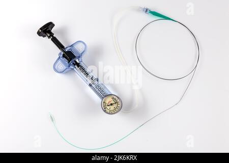 A balloon inflation device used in angioplasty procedure. Mesh metal ...