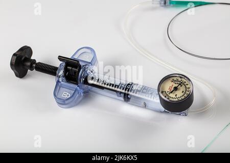 A balloon inflation device used in angioplasty procedure. Mesh metal ...