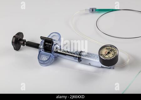 A balloon inflation device used in angioplasty procedure. Mesh metal ...