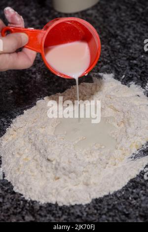 Hands pouring butter into a bowl of flour Stock Photo - Alamy
